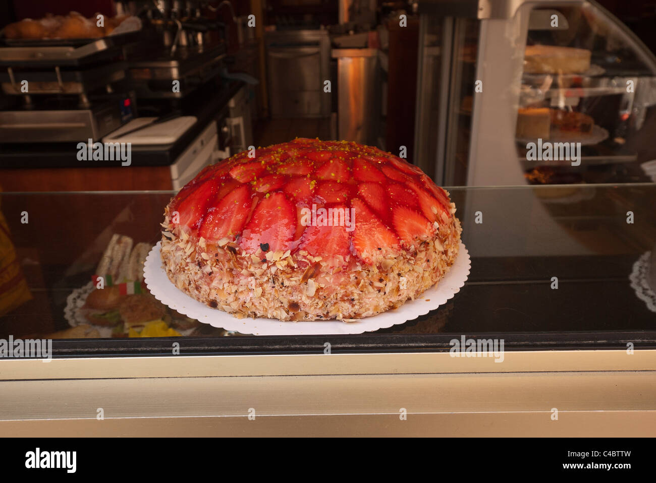 Classic German strawberry cake sits on a counter in the storefront of a ...