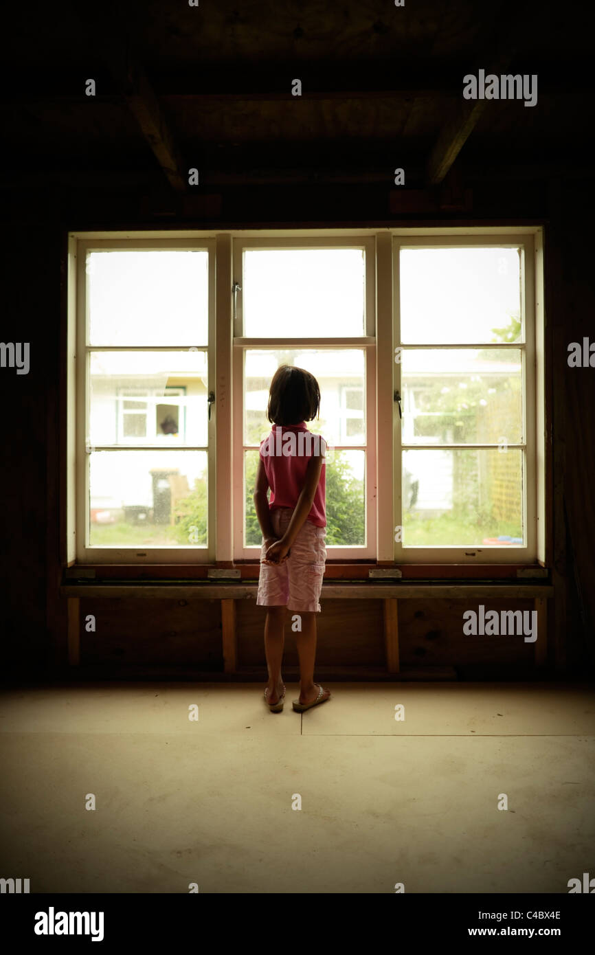 Girl by standing beside shed window Stock Photo - Alamy