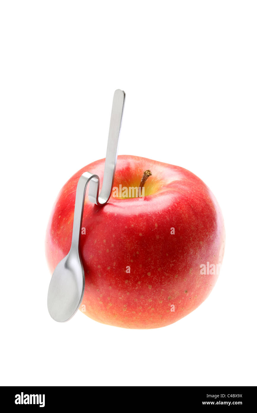 Apple and spoon on a white Stock Photo - Alamy