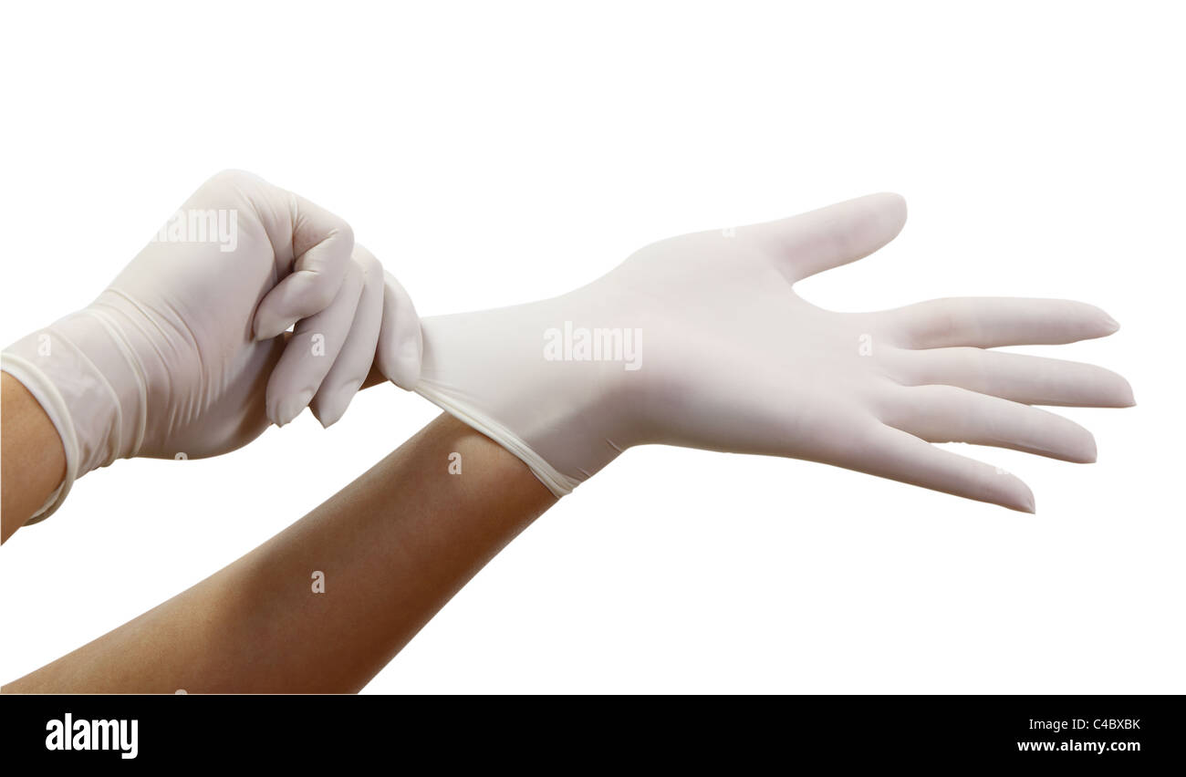 Woman's hands putting on surgical gloves-isolation over white ...