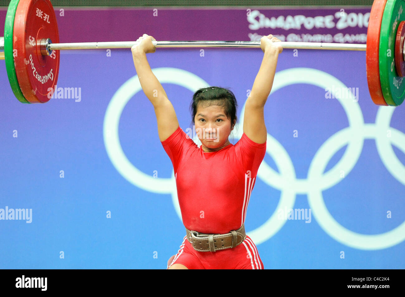 Dewi Safitri of Indonesia in action during her clean and jerk routine ...
