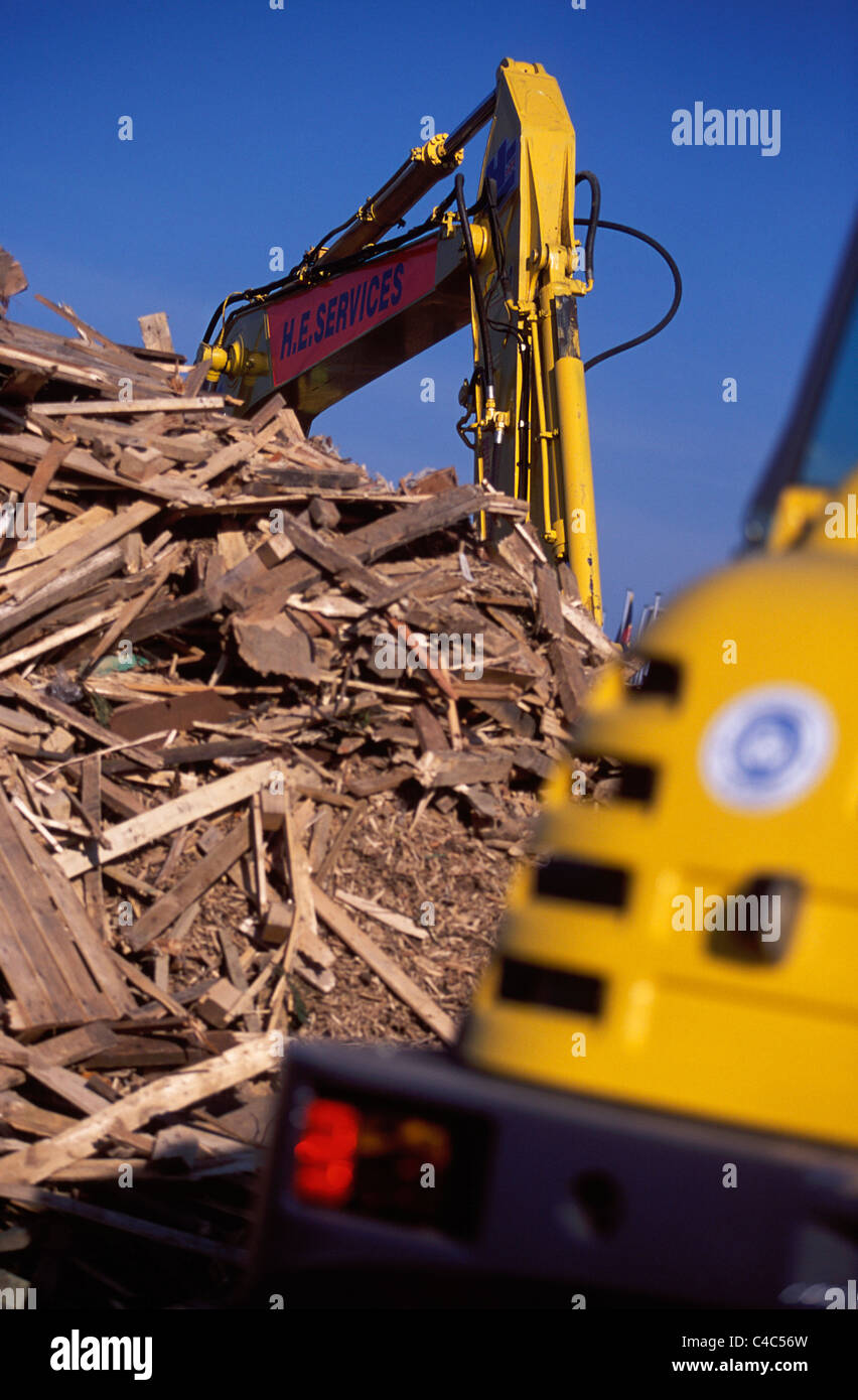 Hydraulic arm and waste timber Stock Photo - Alamy