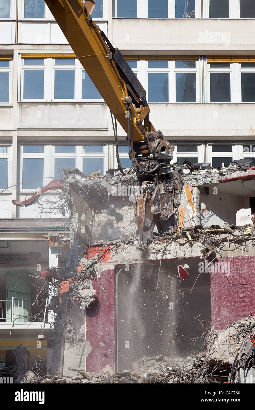 yellow bulldozer is destroying an old building Stock Photo - Alamy