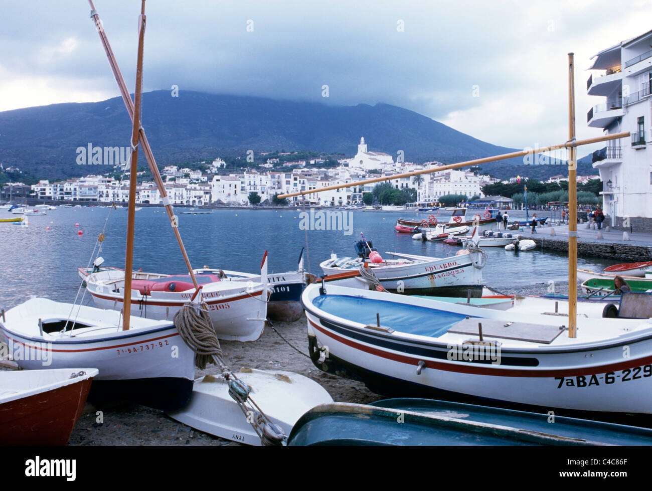 a view of Cadaques and fishing boats in its harbour Stock Photo - Alamy