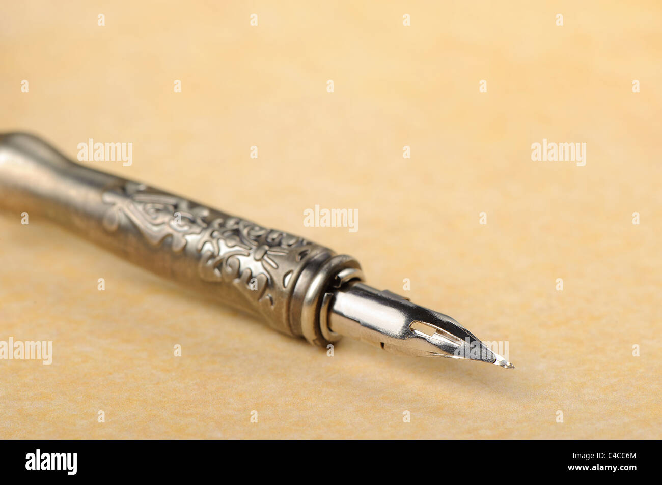Feather quill an old paper. Photo closeup Stock Photo - Alamy