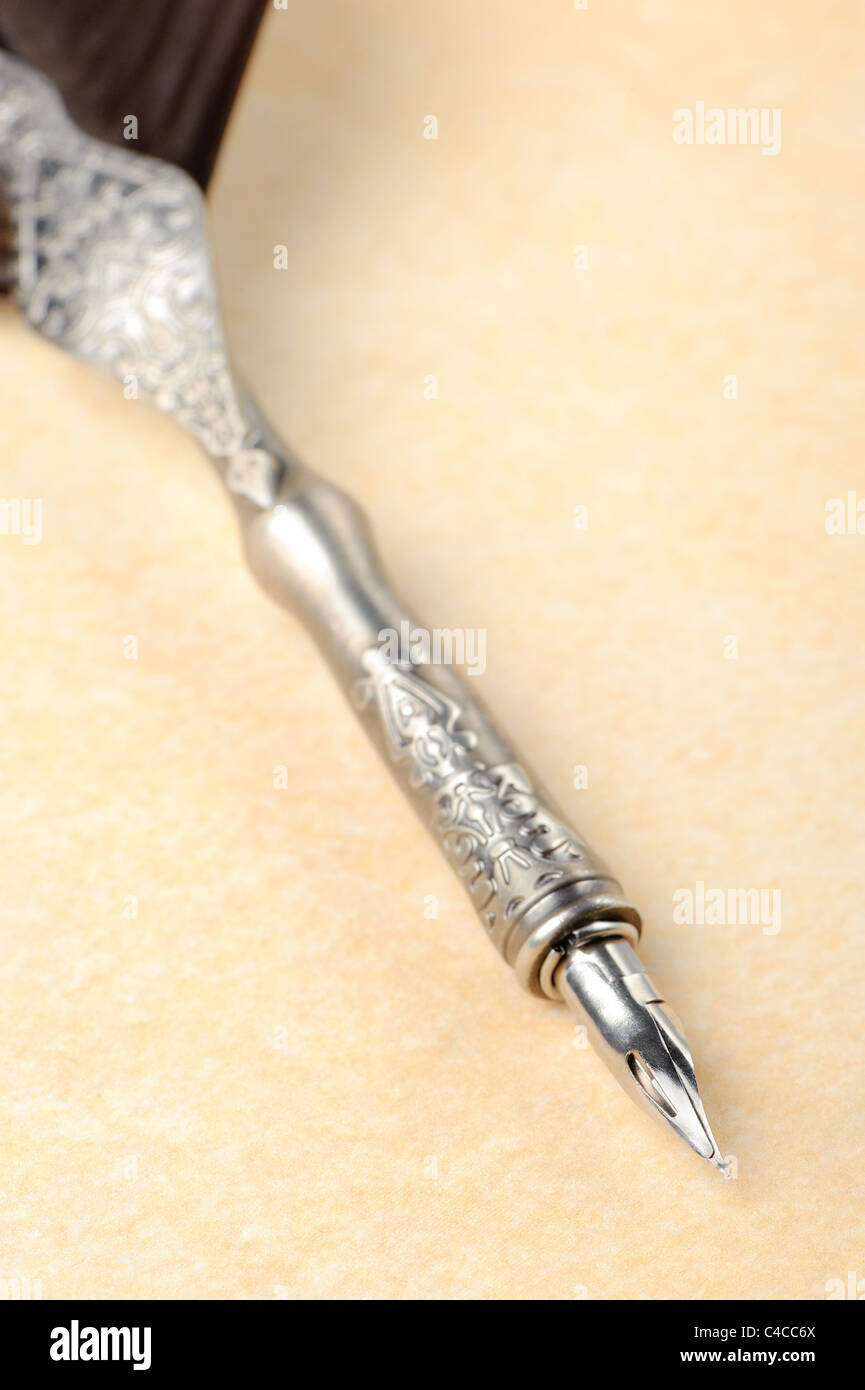 Feather quill an old paper. Photo closeup Stock Photo - Alamy