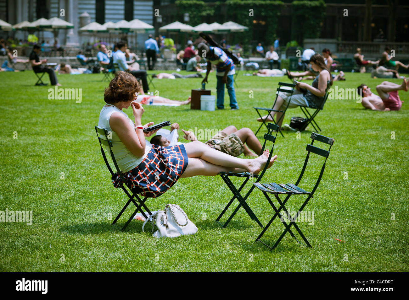 A reader uses her Amazon Kindle ereader in Bryant Park in New York on ...