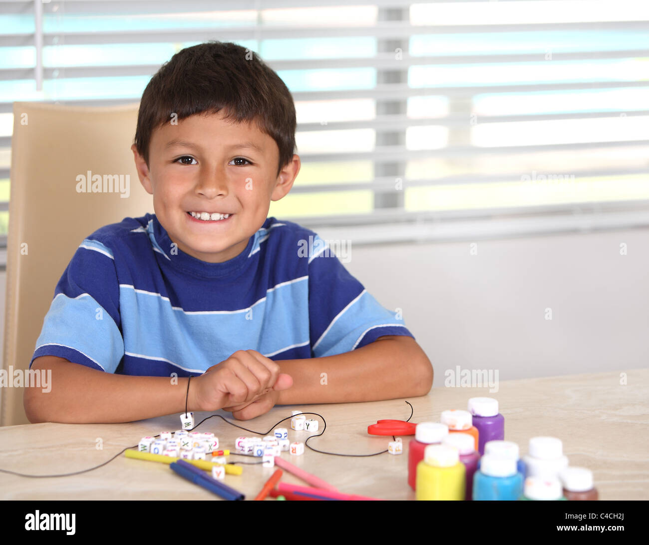Hispanic or Latino boy having fun playing at crafts Stock Photo - Alamy