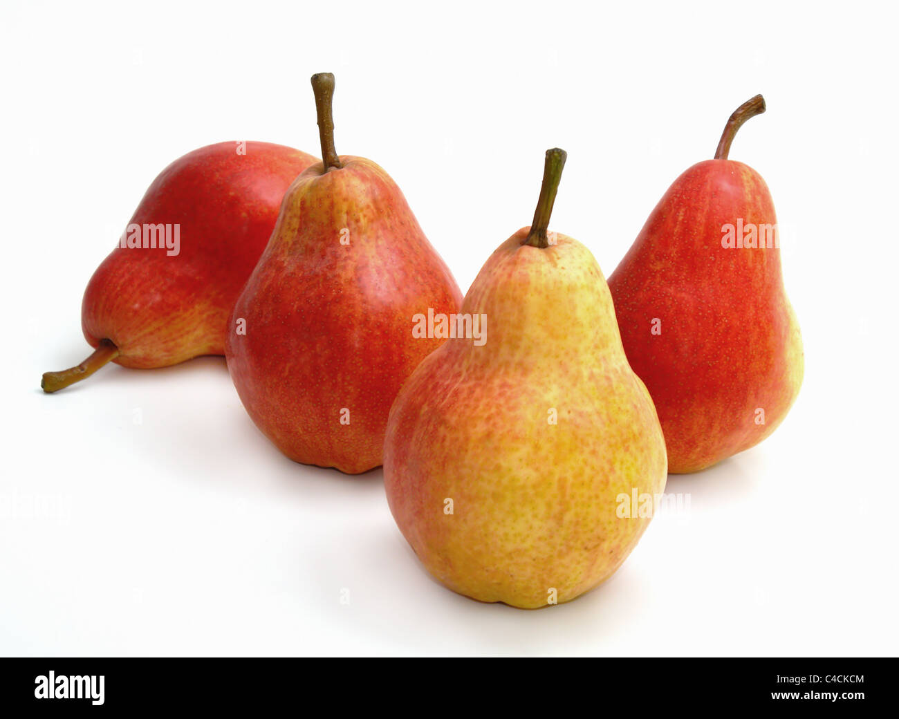 Four red pears on a white background Stock Photo - Alamy