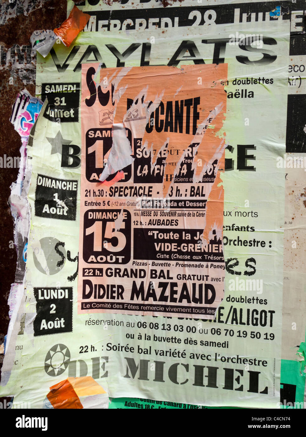 Out of date, torn and defaced posters for local cultural events on a ...