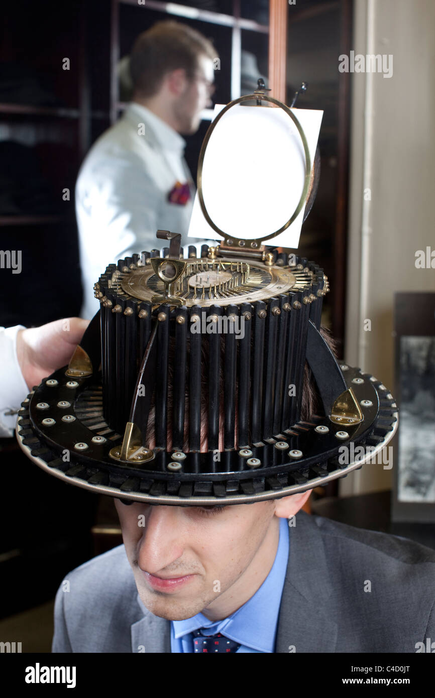 Man with conformateur device on head whilst having head measured for ...