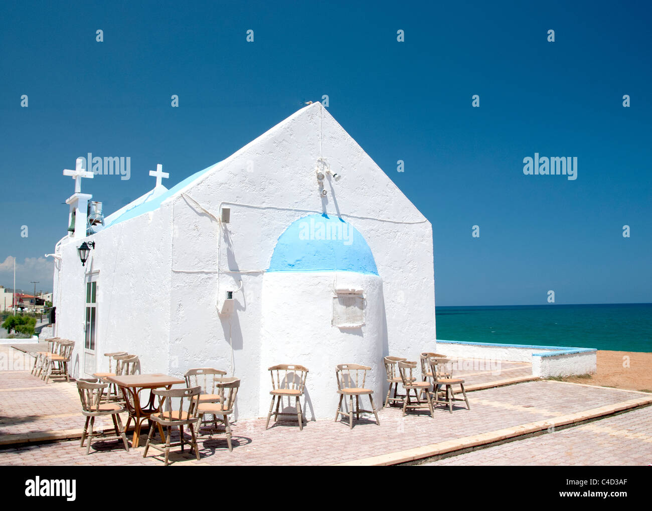 A Pretty Greek Orthodox Church on a headland in Crete with the aegean ...