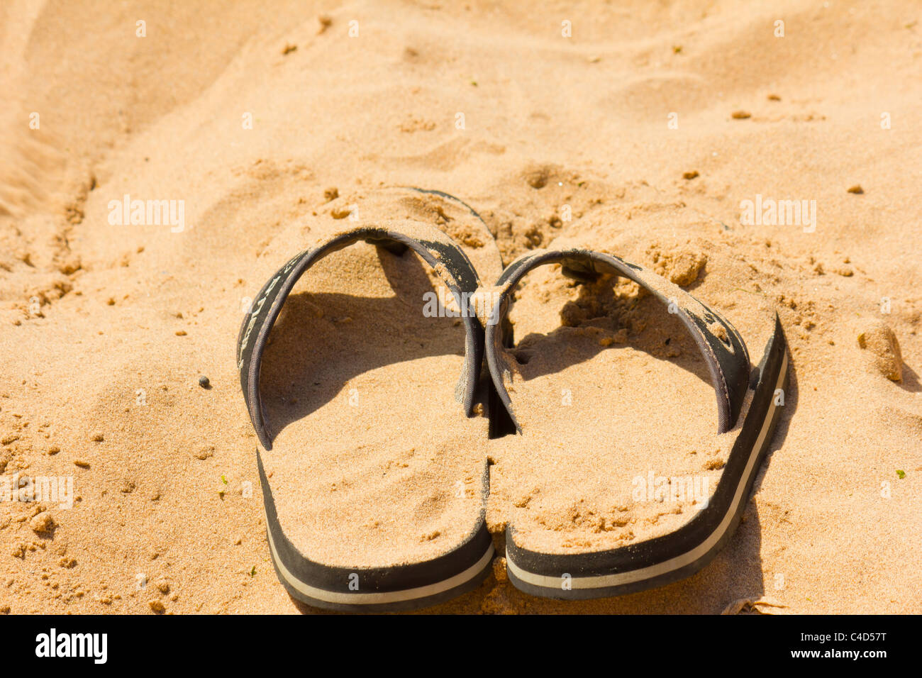 sandals in the sand Stock Photo - Alamy