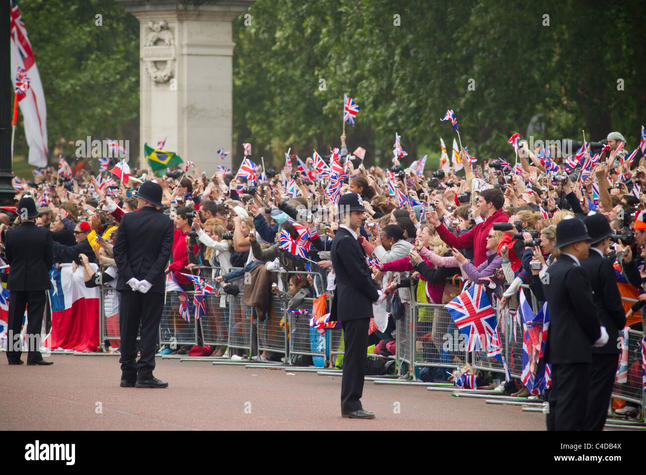 The crowds wait for the return of the Queen and Prince Philip after the ...