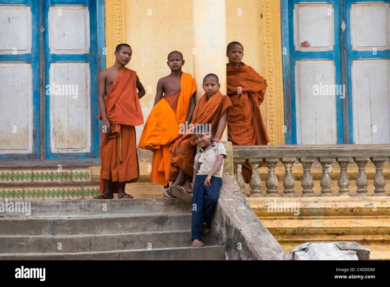 A young boy and a group of Buddhist monks are enjoying a relaxing ...