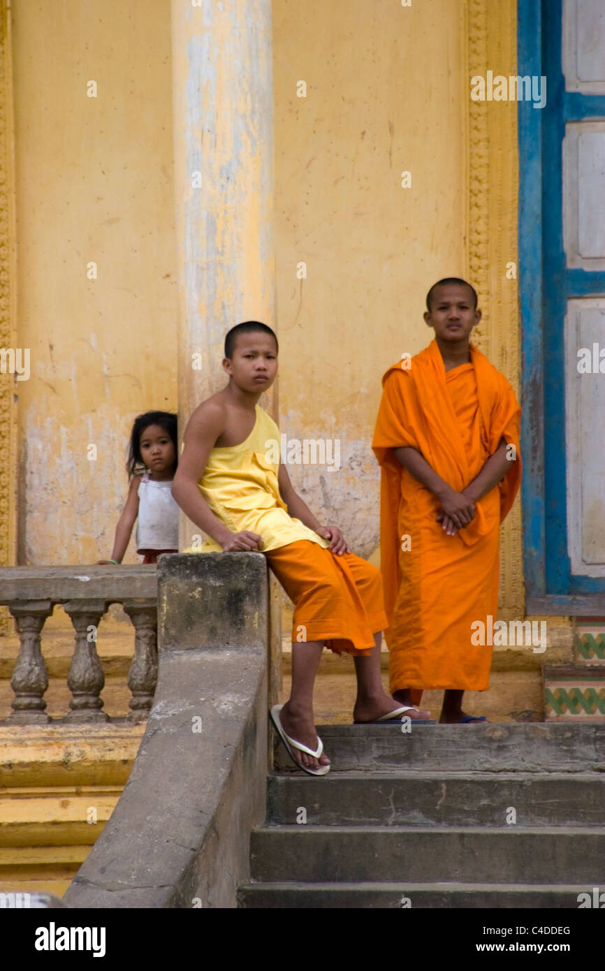 A young girl and two Buddhist monks are enjoying a relaxing afternoon ...