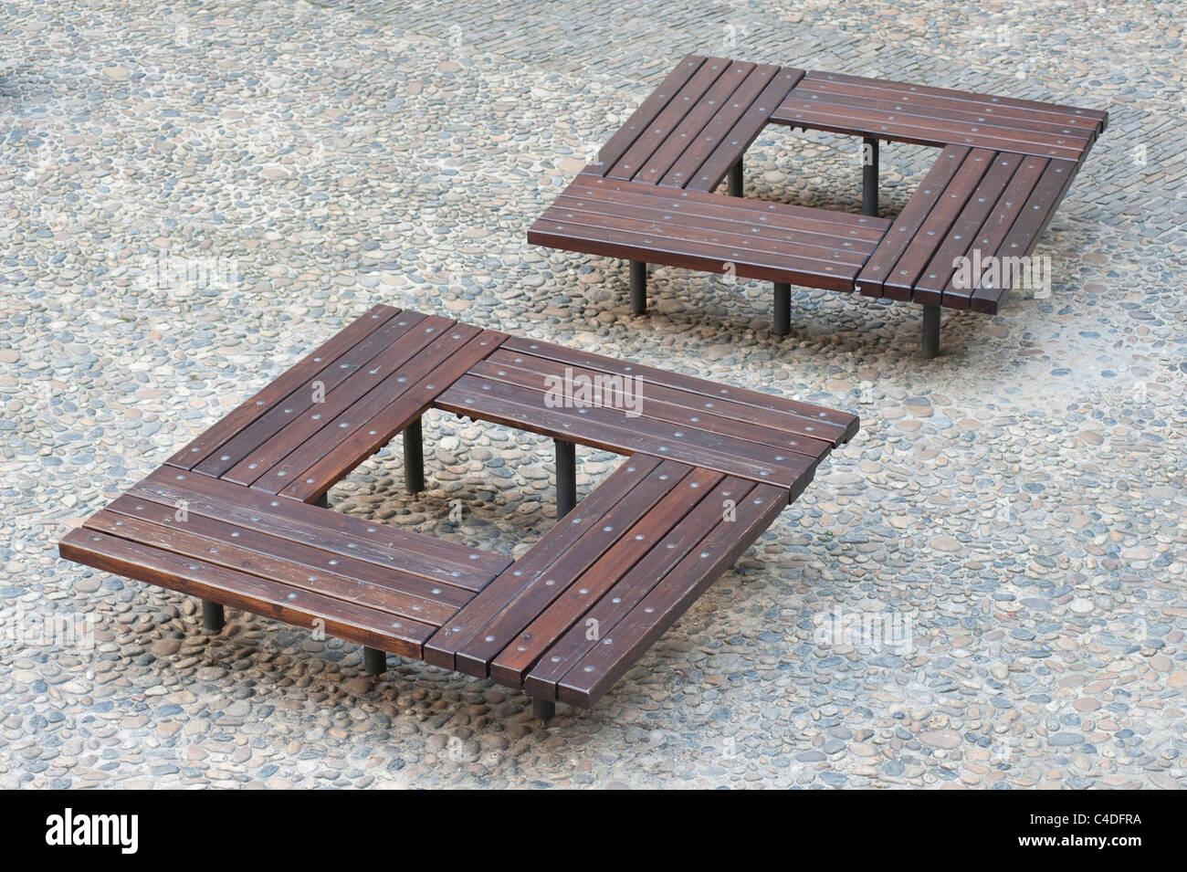 Modern square wooden benches on a cobbled surface at Prague Castle in ...