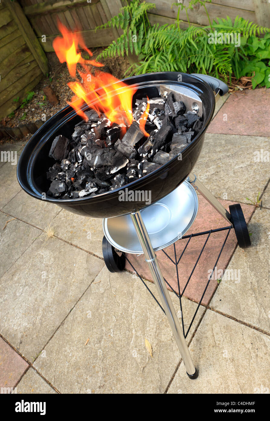 a traditional style bbq with flames coming through the grill Stock ...