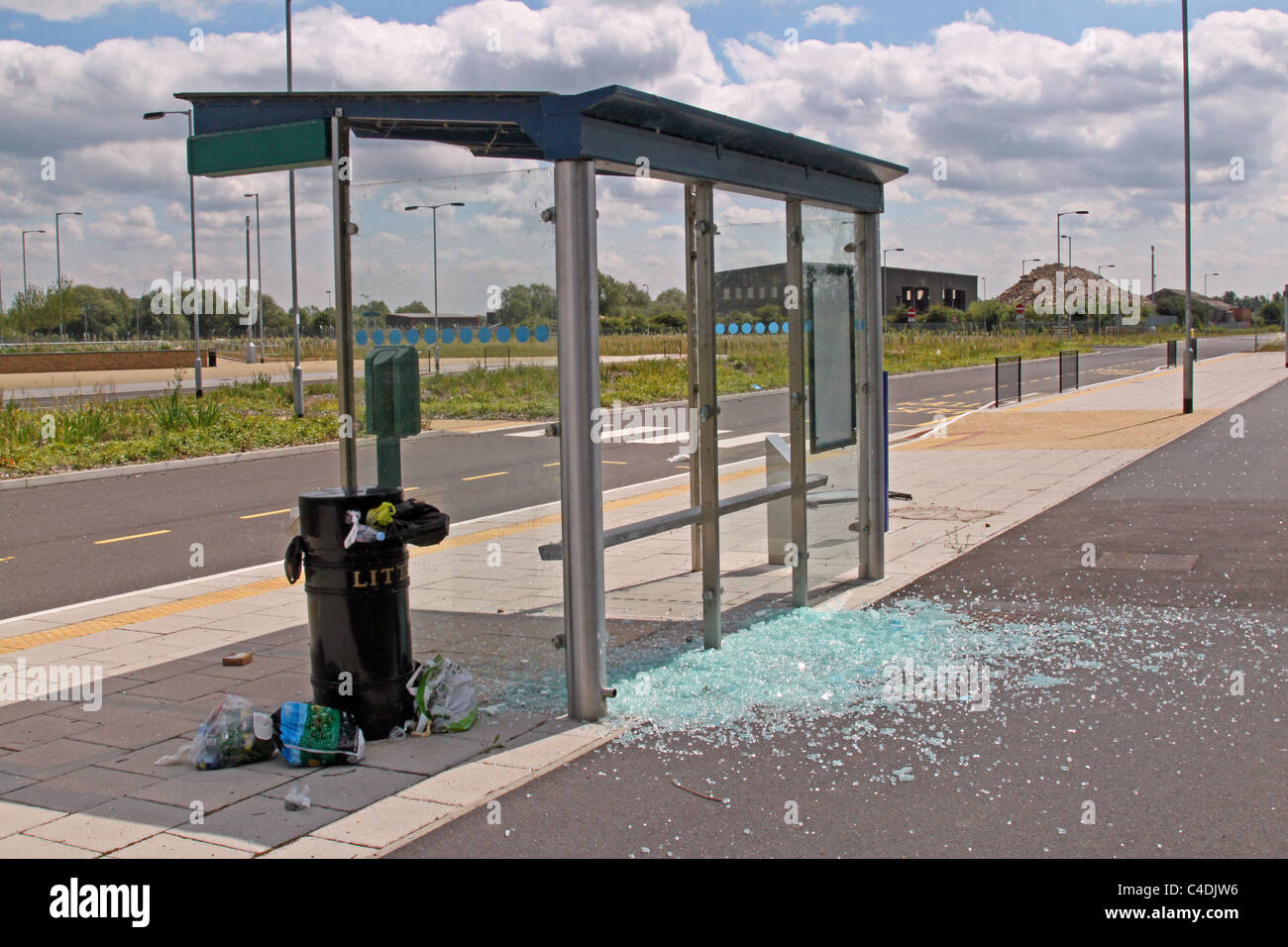 Bus stop vandalised by smashing the glass windows Stock Photo - Alamy