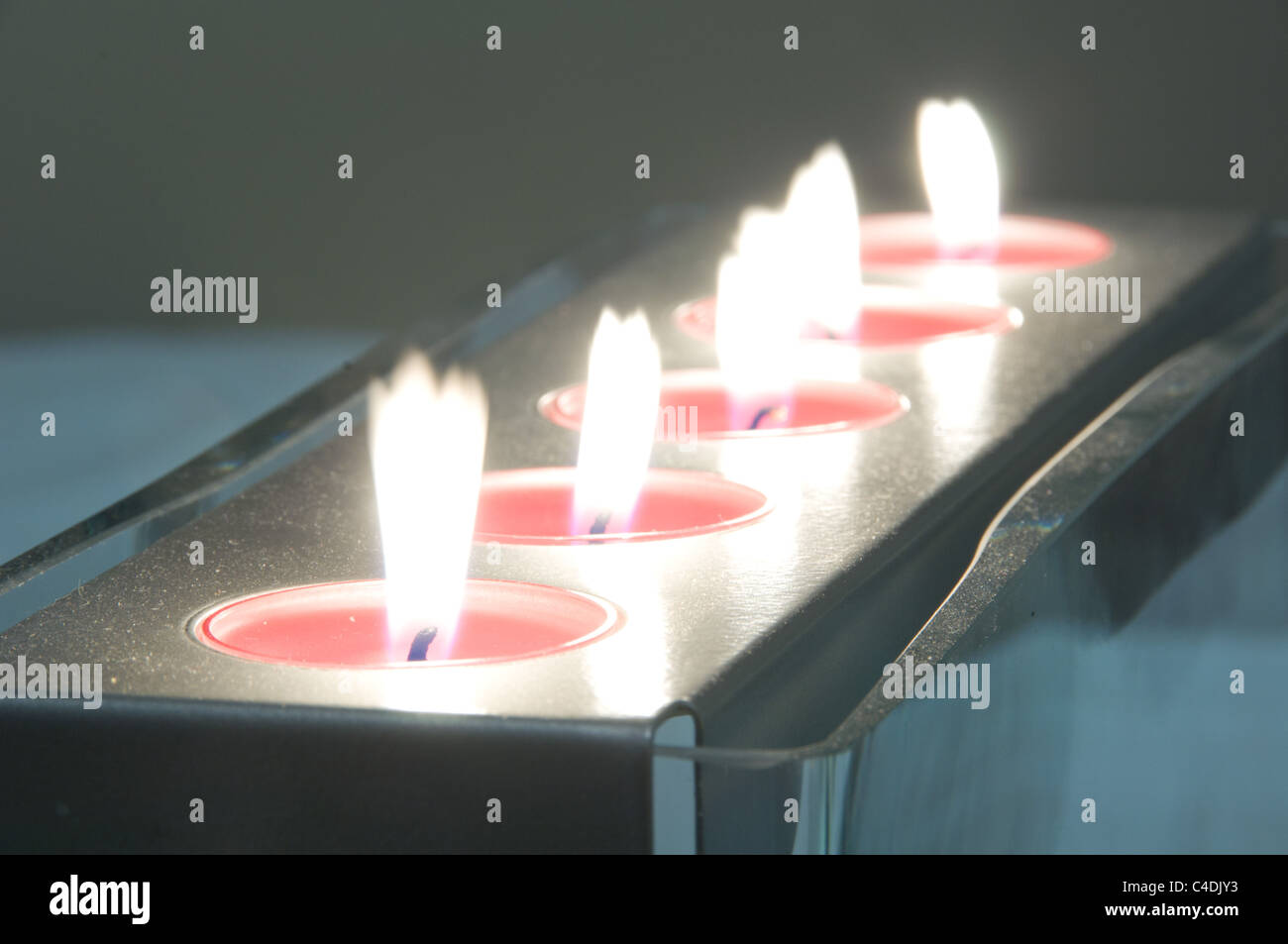 A Candle Holder with Five Candles Lit with a Flame Stock Photo - Alamy