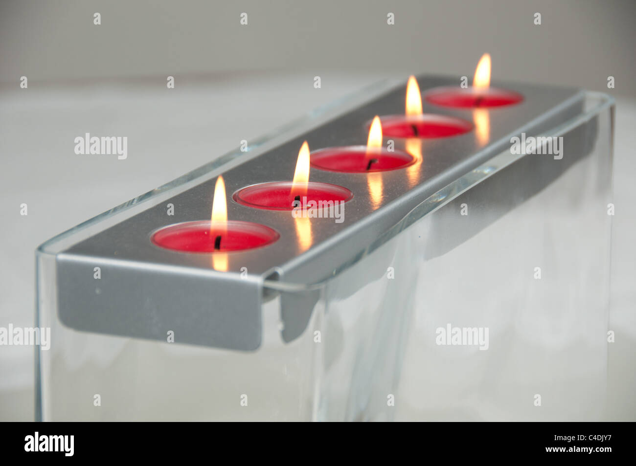 A Candle Holder with Five Candles Lit with a Flame Stock Photo - Alamy