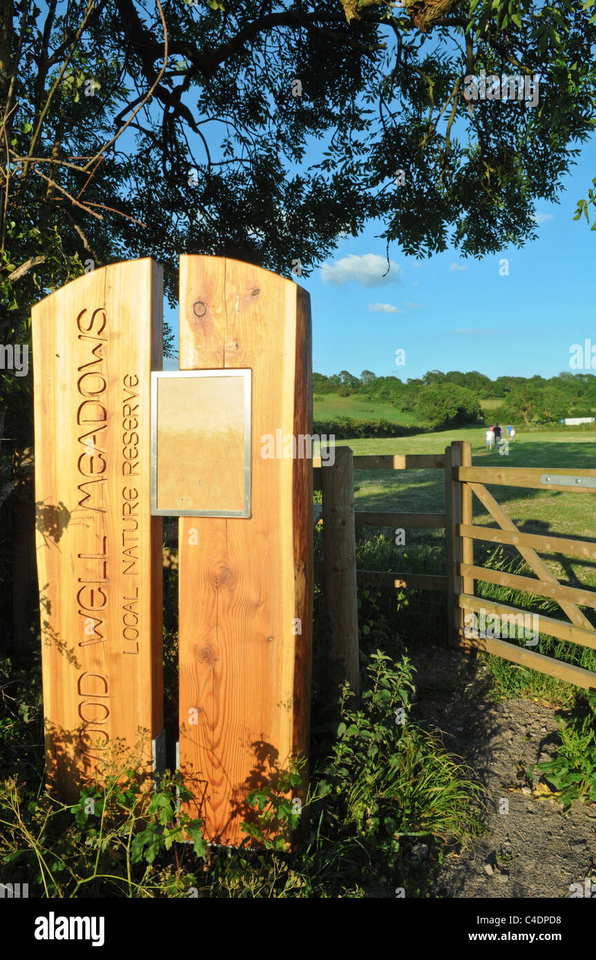 Open gate and wooden sign to an English nature reserve on a summer ...