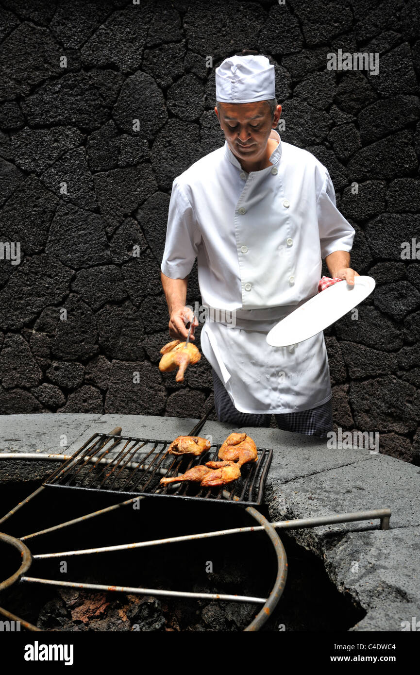 Chef cooking over volcanic heat El Diablo restaurant, Timanfaya ...