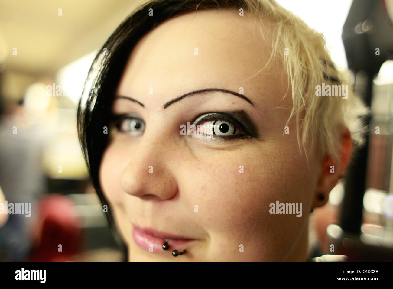 Gothic enthusiast wearing funky colored eye contact lenses at the ...