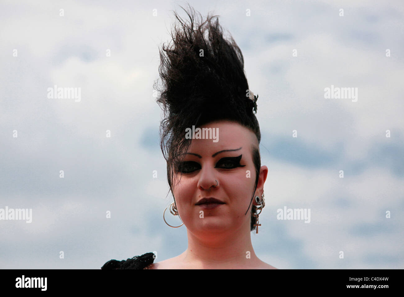 A Gothic enthusiast with Mohawk hairstyle spiked up with gel at the ...