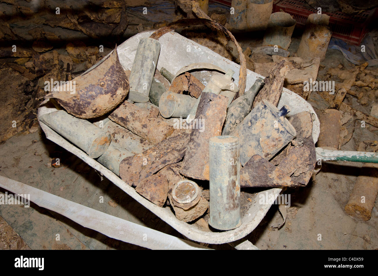 Wheelbarrow filled with First World War helmets and shells, northern ...