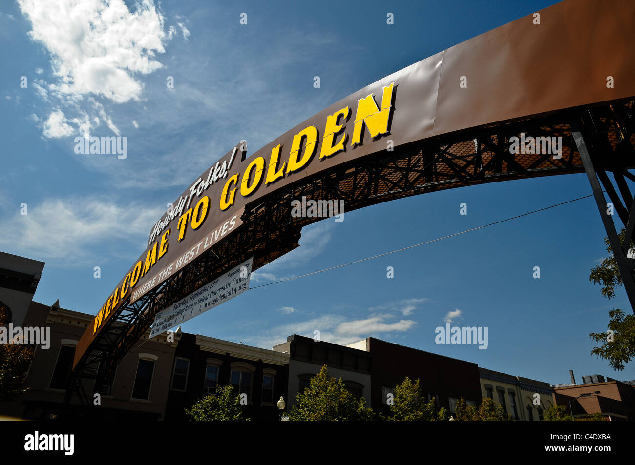 Welcome to Golden Colorado sign, set against blue sky with white clouds ...