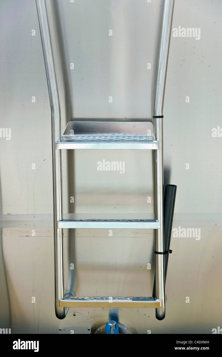 A steel access ladder mounted on the back of a bulk liquid tank ...