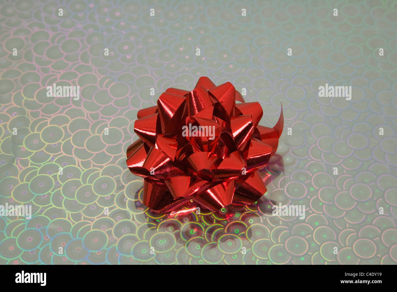 Red bow on white holographic paper Stock Photo - Alamy