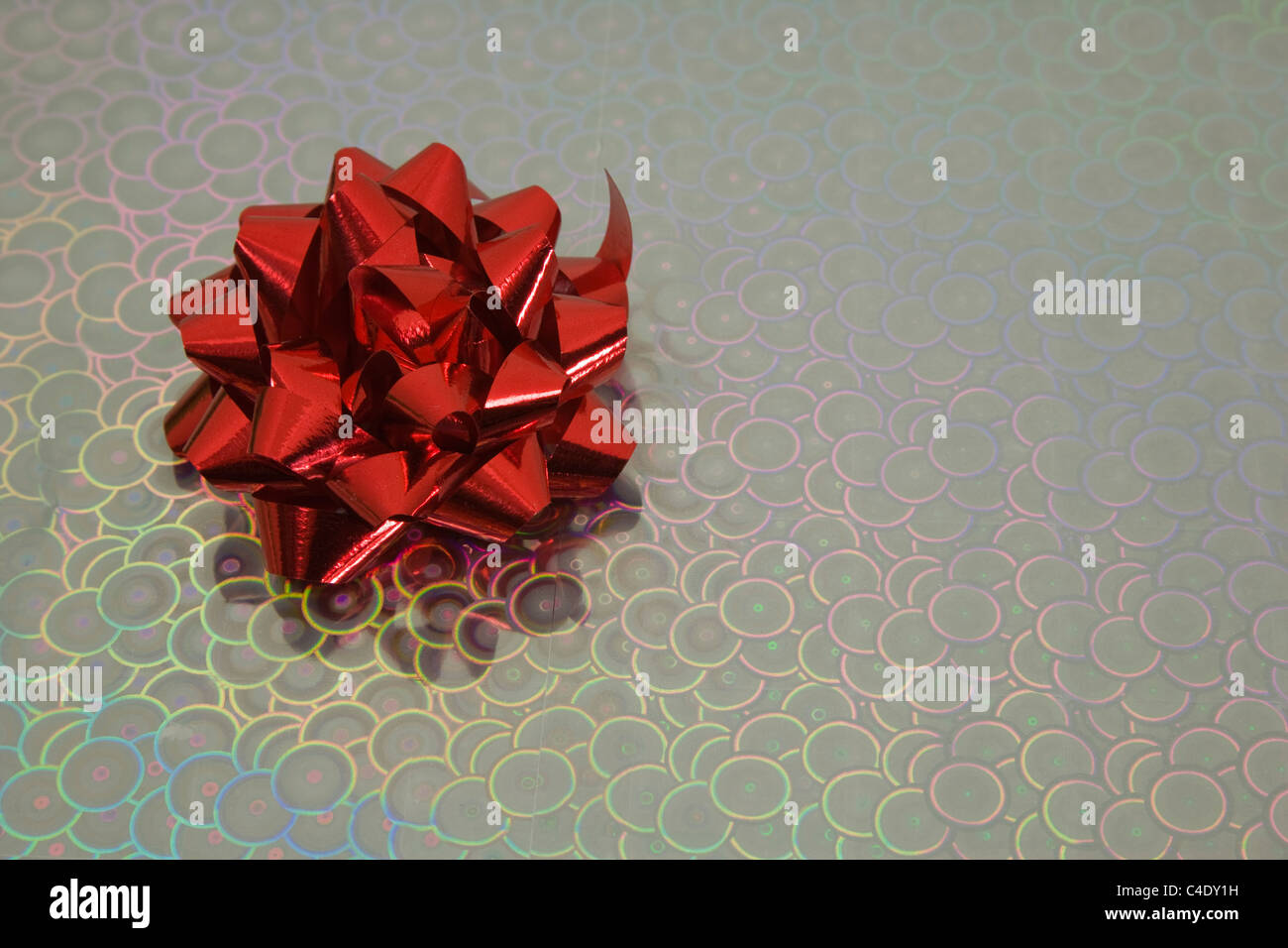 Red bow on white holographic paper Stock Photo - Alamy