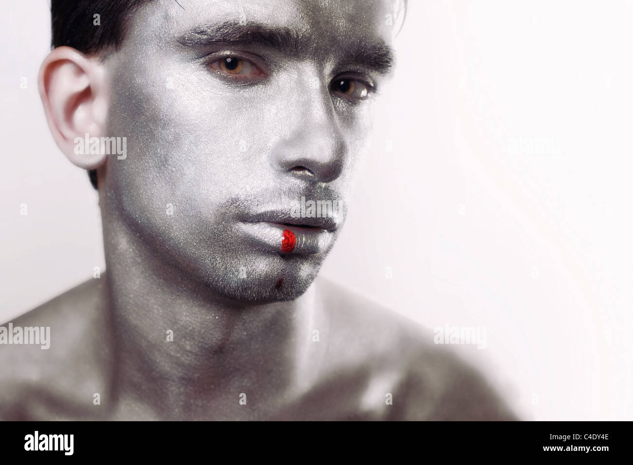 Face of young man with silver makeup and blood closeup Stock Photo - Alamy