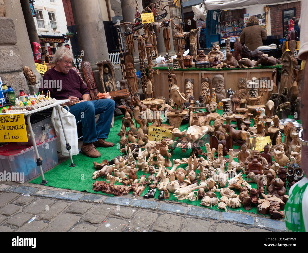 A stall selling carved wooden ornaments in Whitby Market Place Stock ...