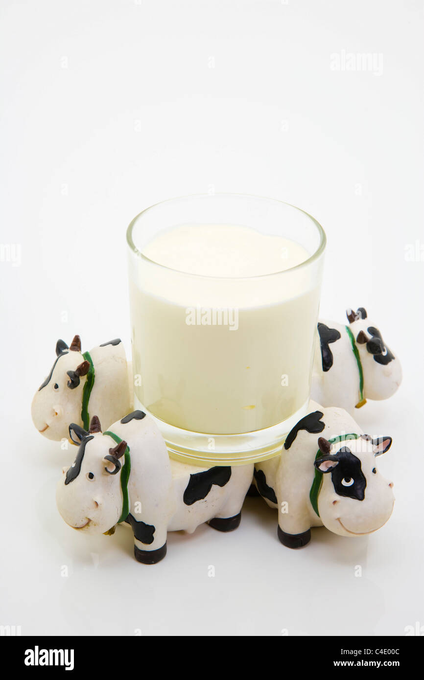 Four clay cows holding a glass of soured cream Stock Photo - Alamy
