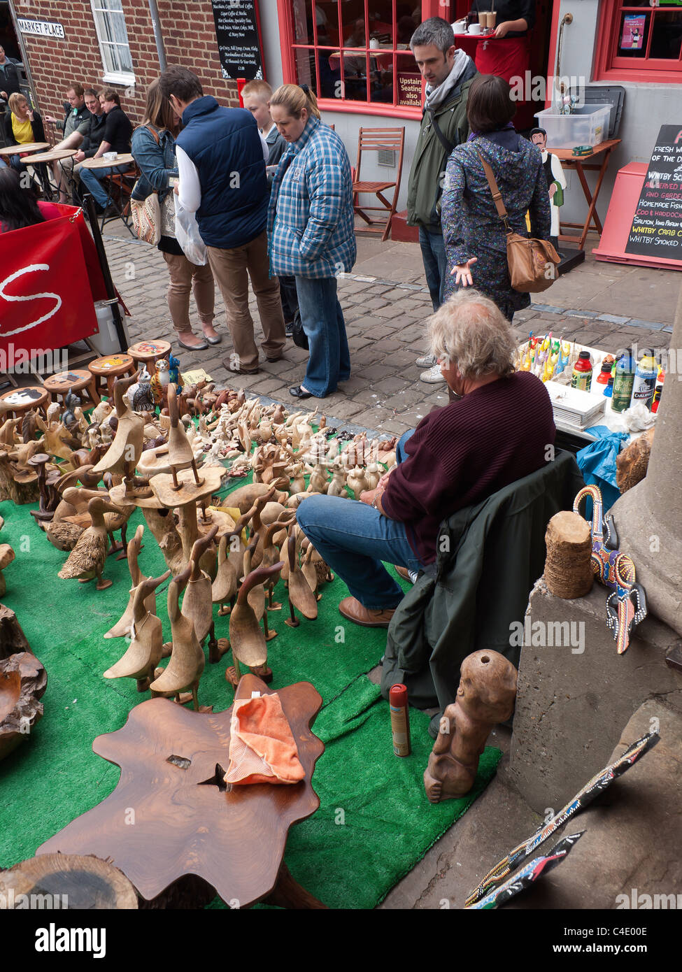 A stall selling carved wooden ornaments in Whitby Market Place Stock ...
