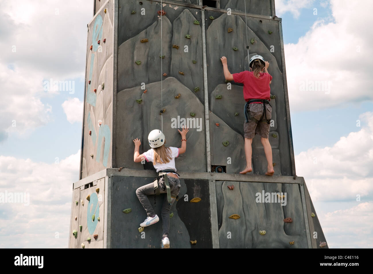 Two young girls scaling a climbing wall Stock Photo - Alamy