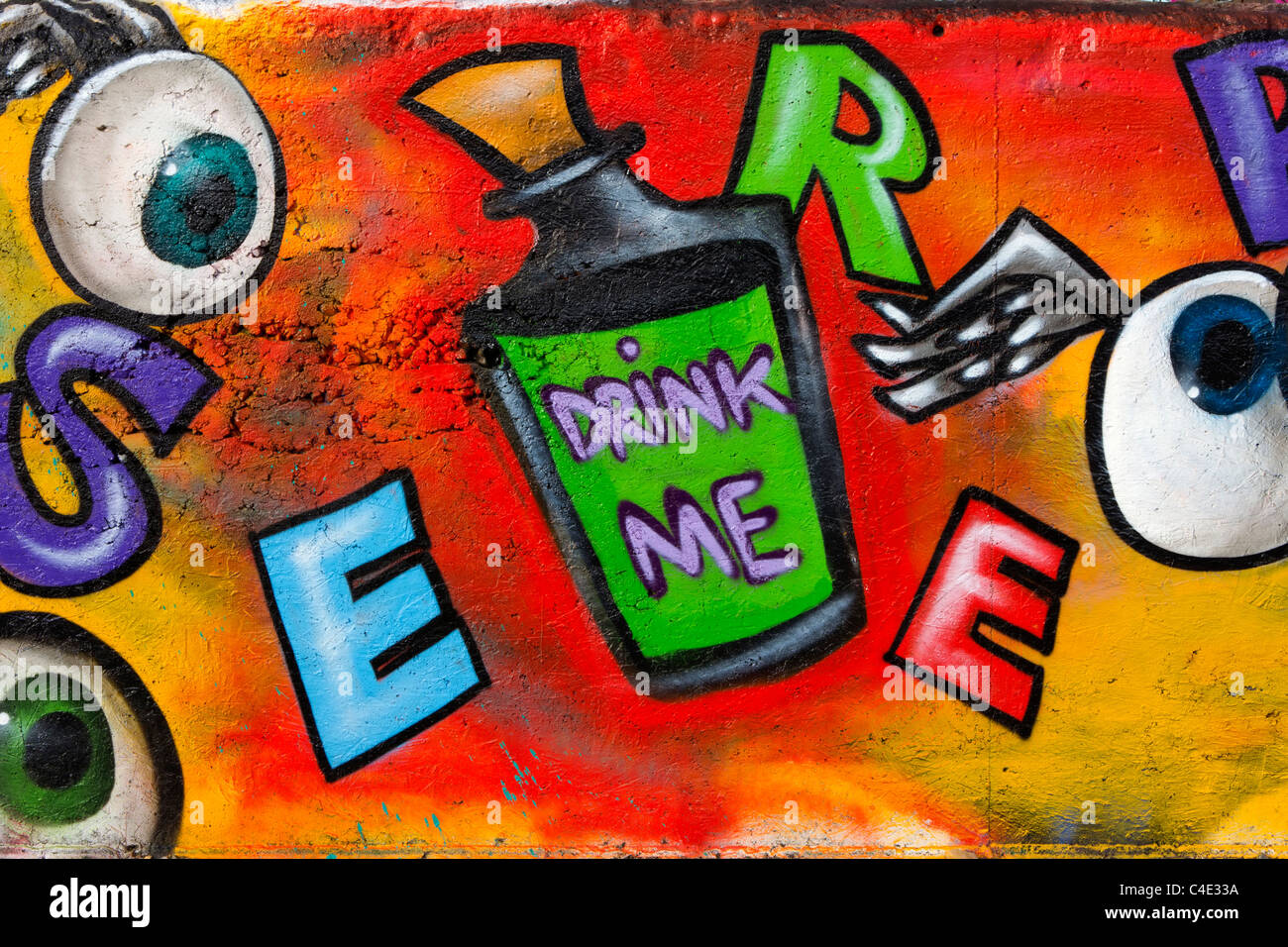 A Graffiti Mural with a bottle labeled "drink me Stock Photo - Alamy