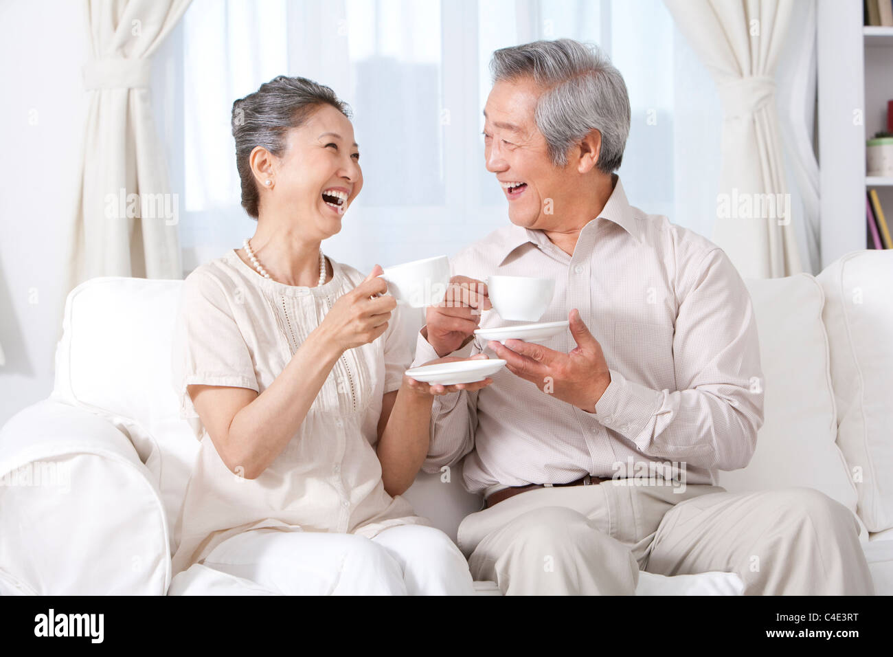 Happy Couple Enjoying Tea Stock Photo - Alamy