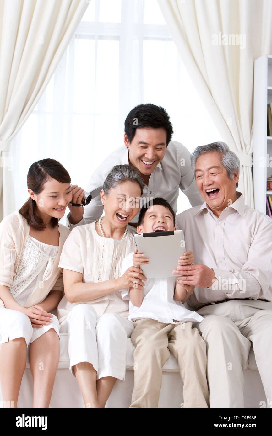 Happy Family Using an iPad together Stock Photo - Alamy