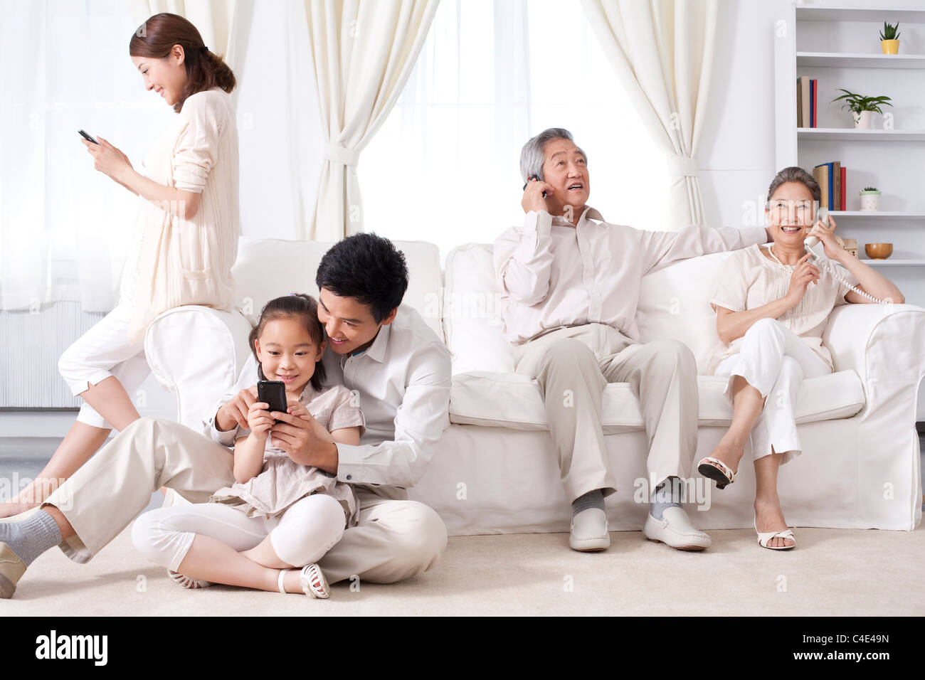 Multi-Generational Family Using Phones Stock Photo - Alamy