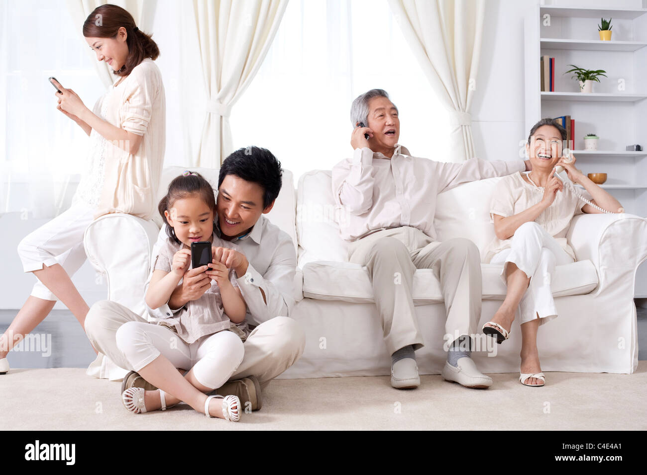 Multi-Generational Family Using Phones Stock Photo - Alamy