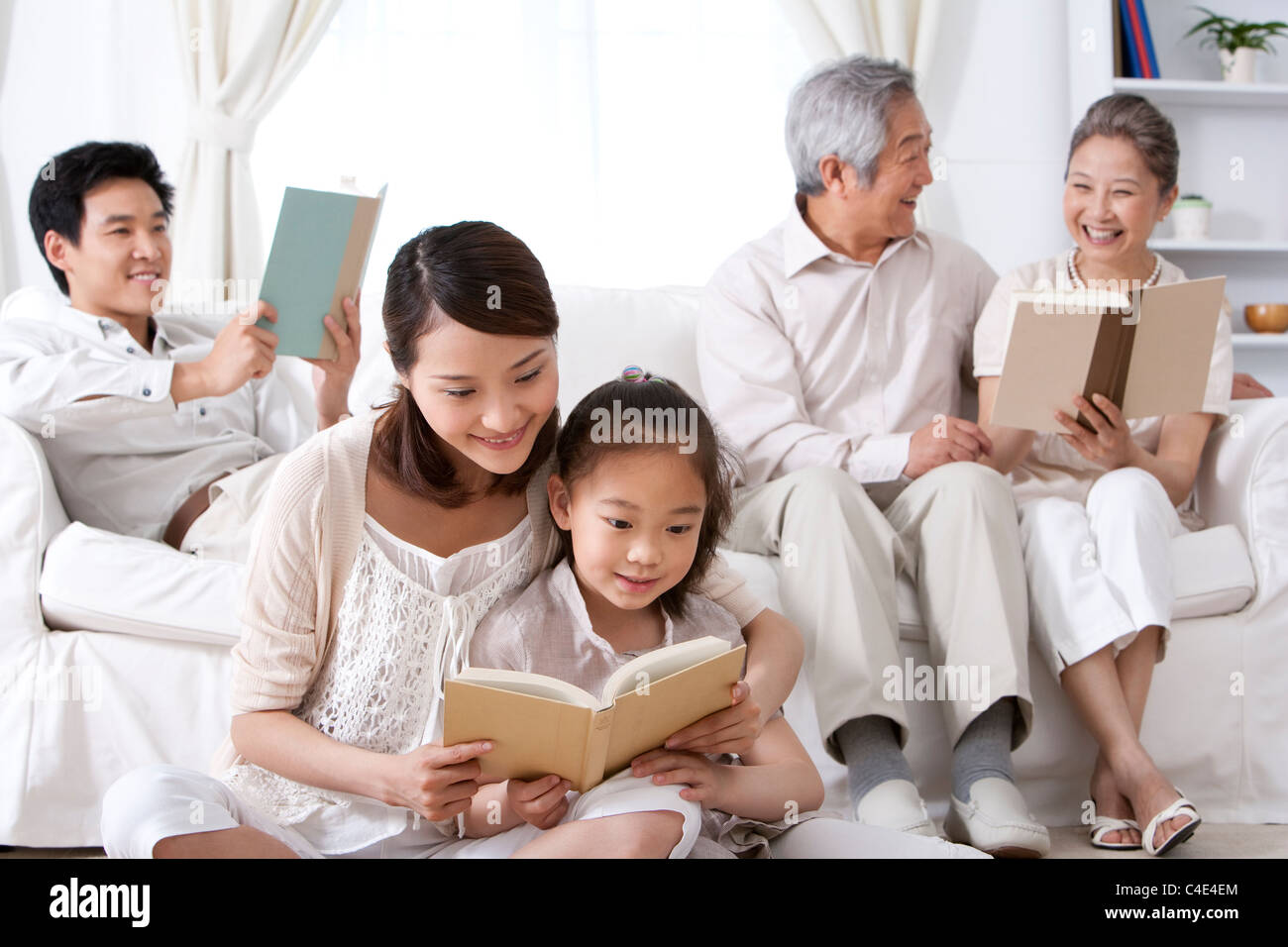 Happy Family Reading Together Stock Photo - Alamy