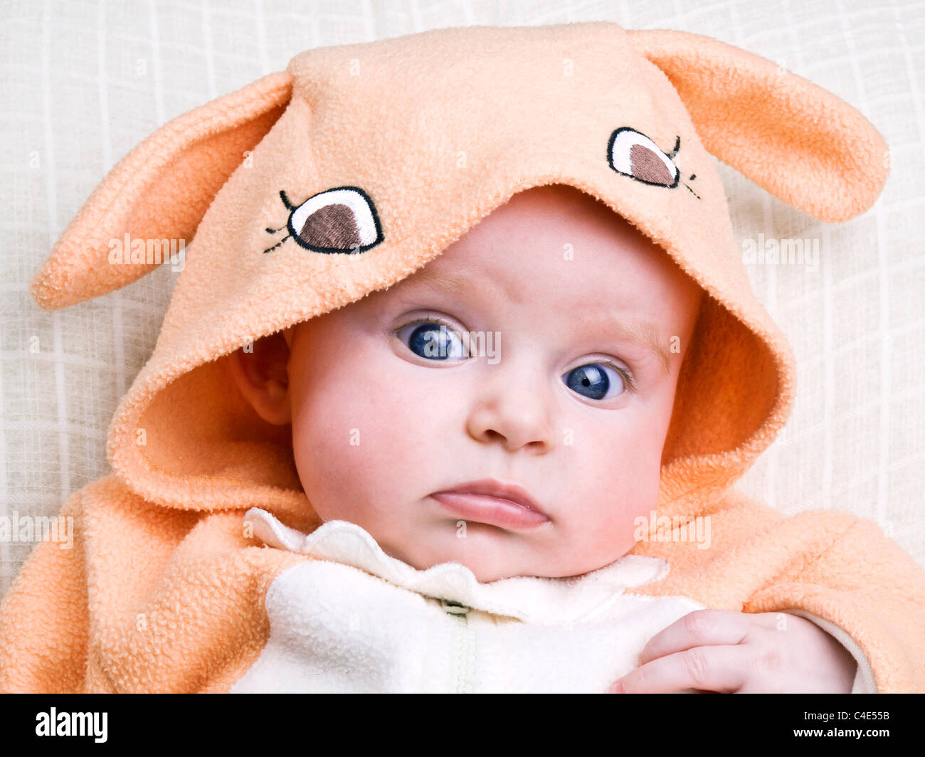 Newborn baby girl wearing easter bunny costume on light background ...