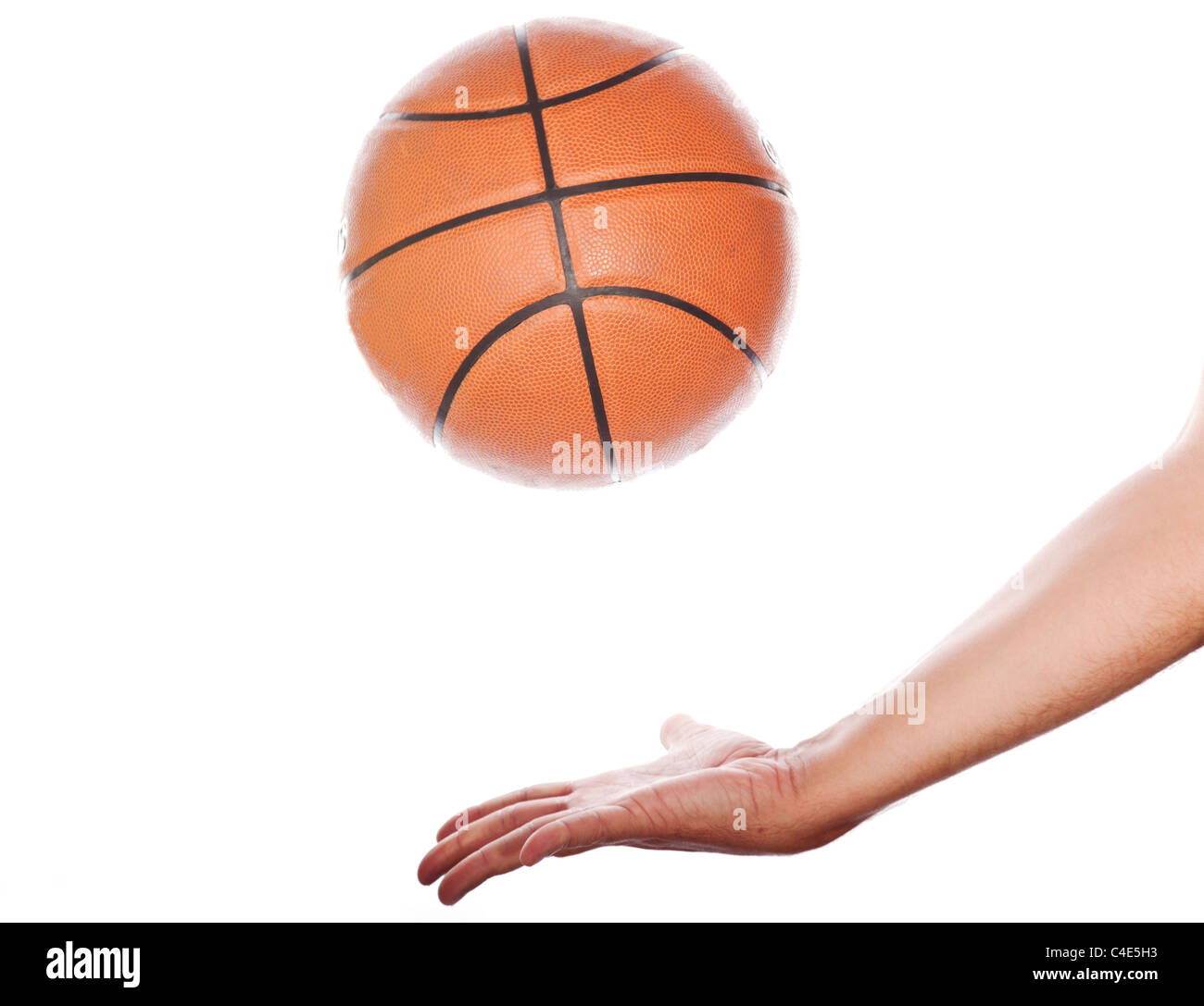 The isolated image of a hand and basketball ball on a white background ...