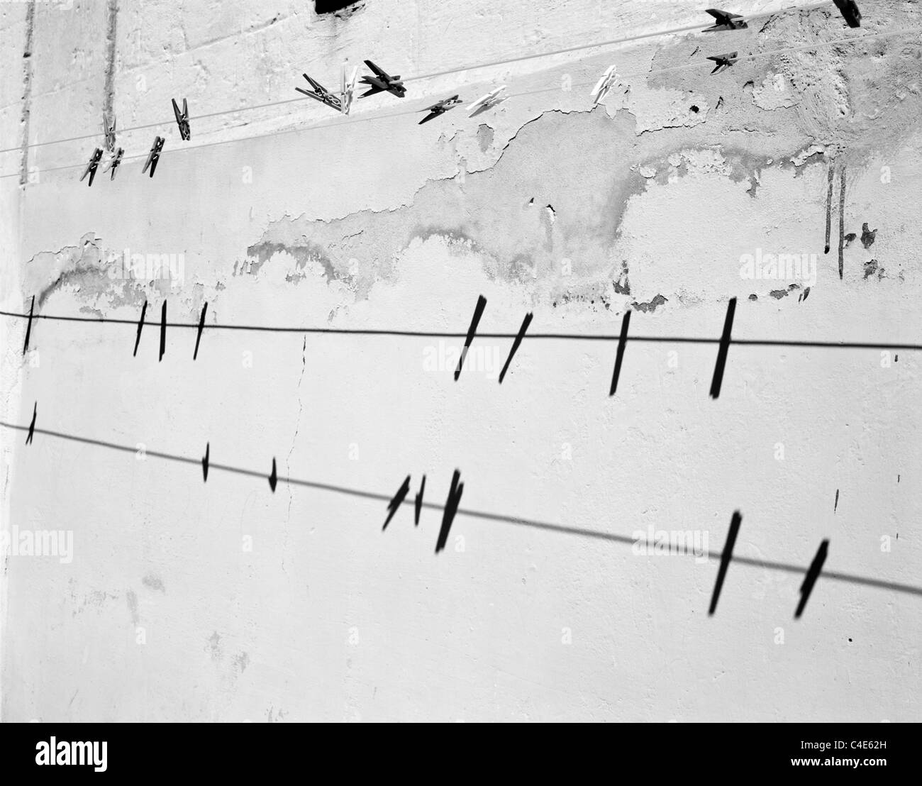 Parallel washing lines with pegs but no clothes hung up together with ...
