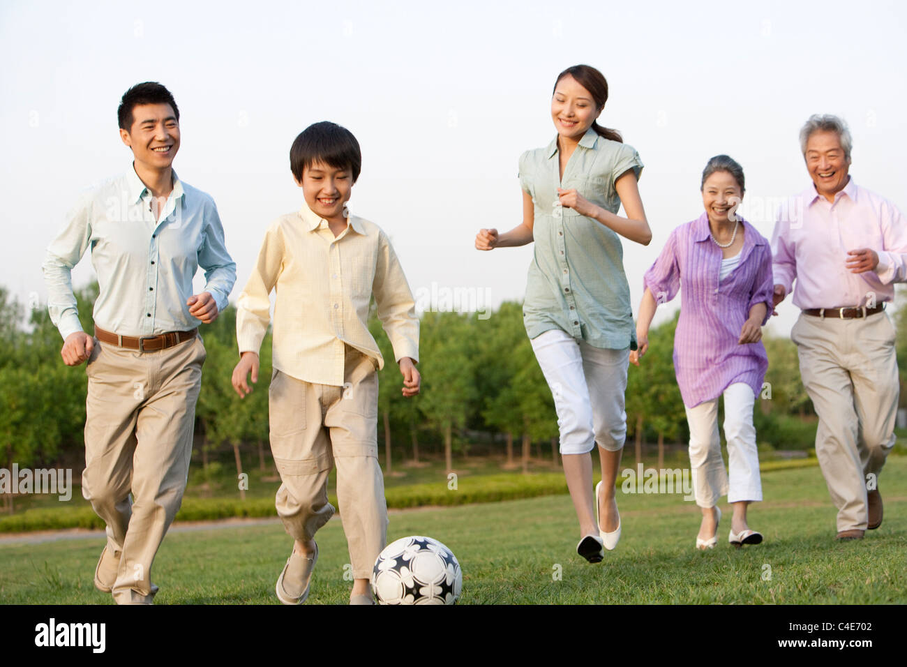 Multi generation family playing soccer hi-res stock photography and ...