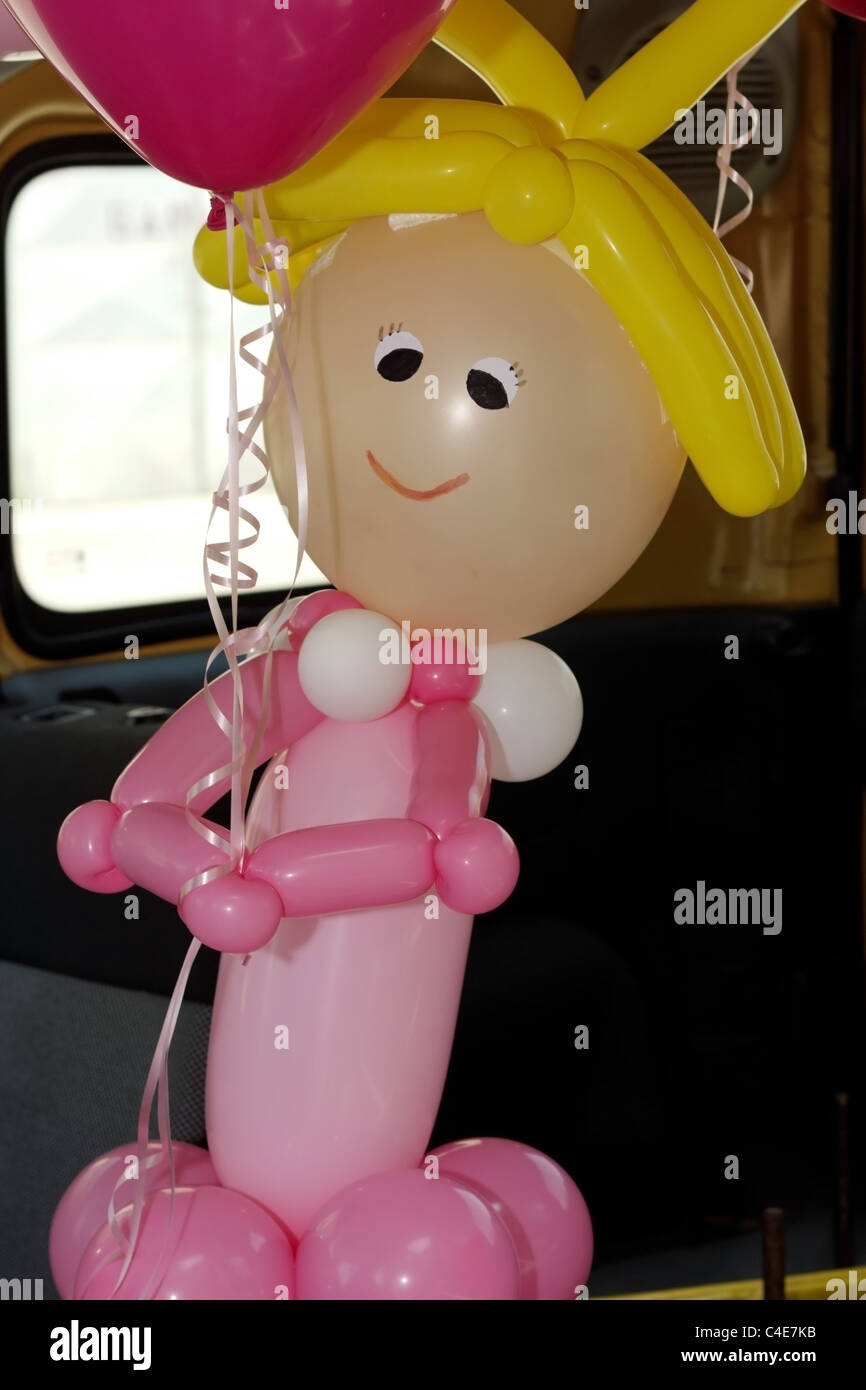 Helium inflated balloons in form of an girl Stock Photo - Alamy